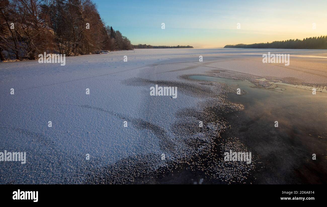 Lake freezing over at Winter , Finland Stock Photo - Alamy