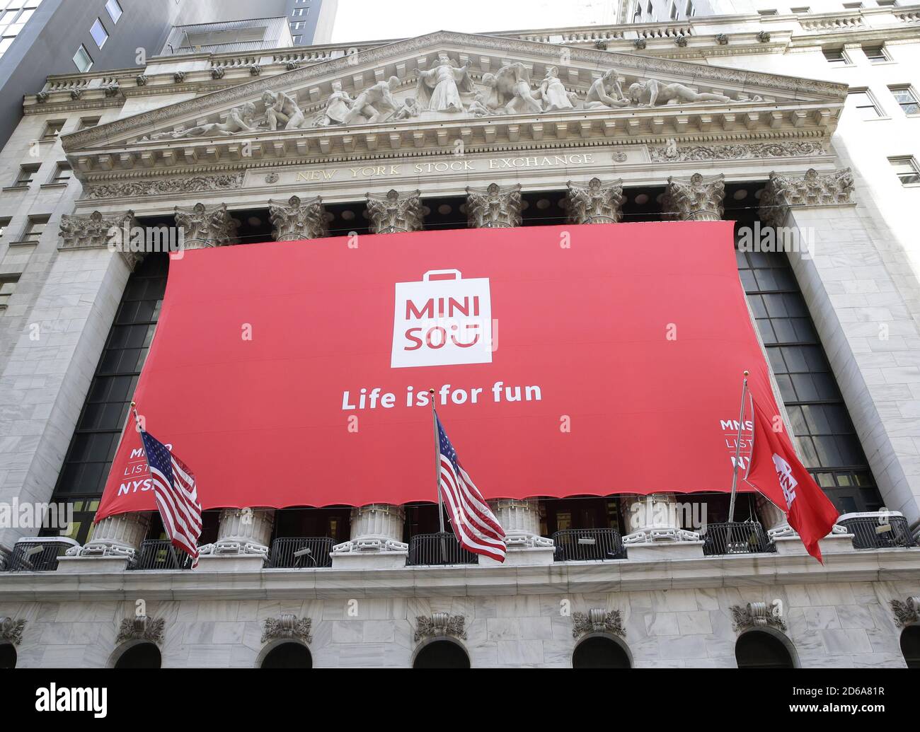 A banner for the Chinese retailer Miniso hangs outside at the New York ...