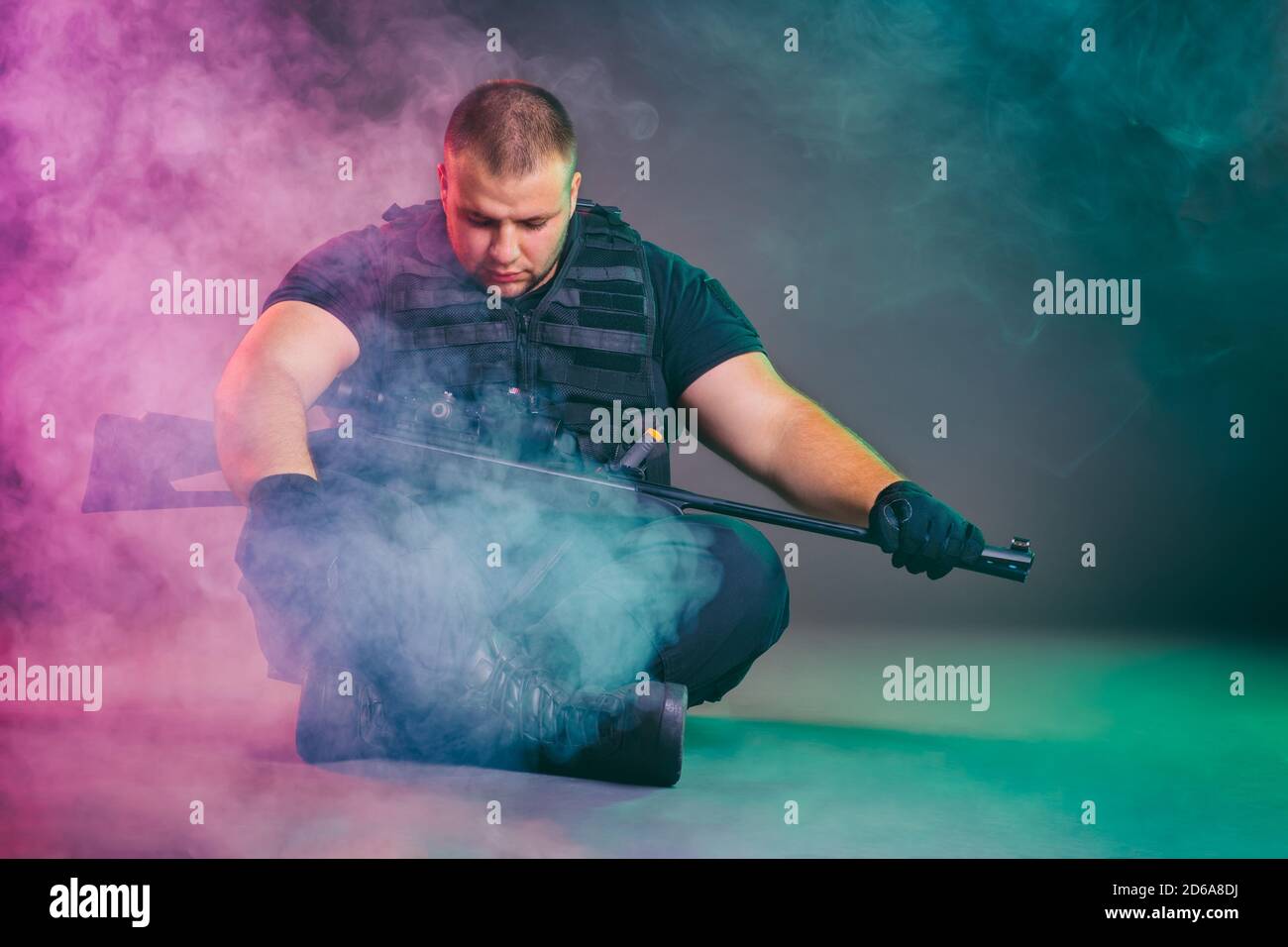 Soldier comes out of the smoke on the battlefield. The concept of ...