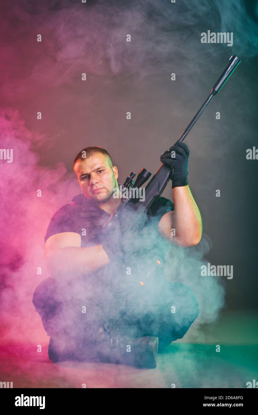 Soldier comes out of the smoke on the battlefield. The concept of ...