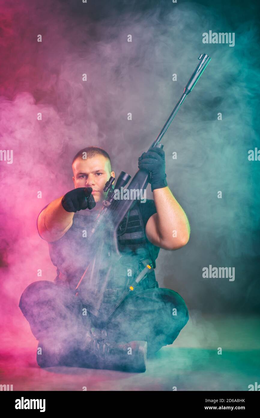 Soldier comes out of the smoke on the battlefield. The concept of ...