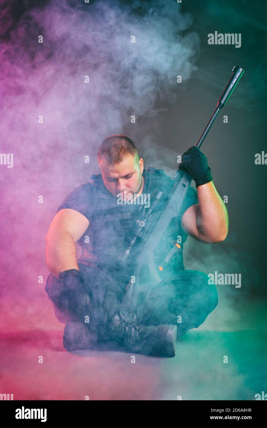 Soldier comes out of the smoke on the battlefield. The concept of ...