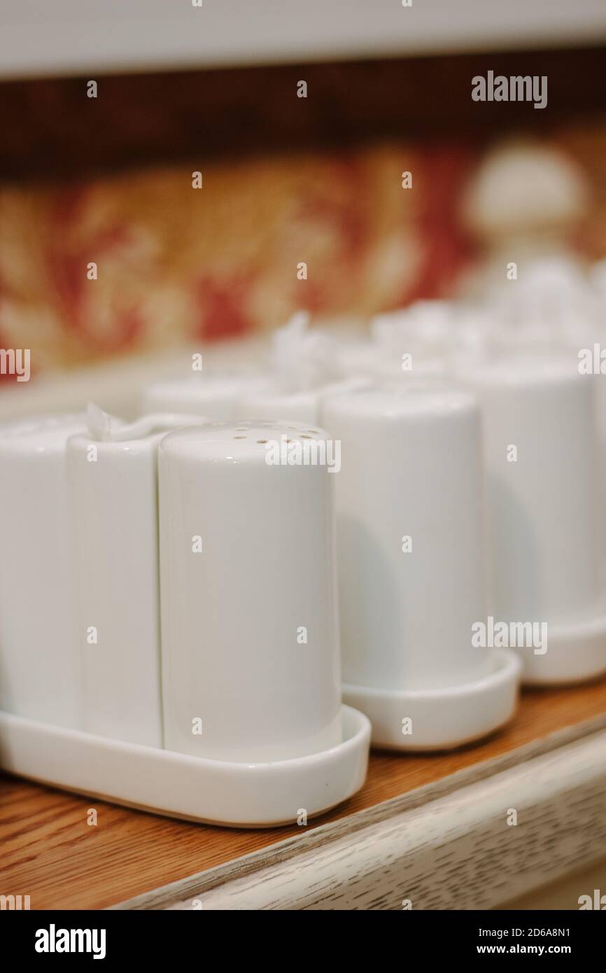 Row of salt shakers at restaurant during dinner Stock Photo - Alamy
