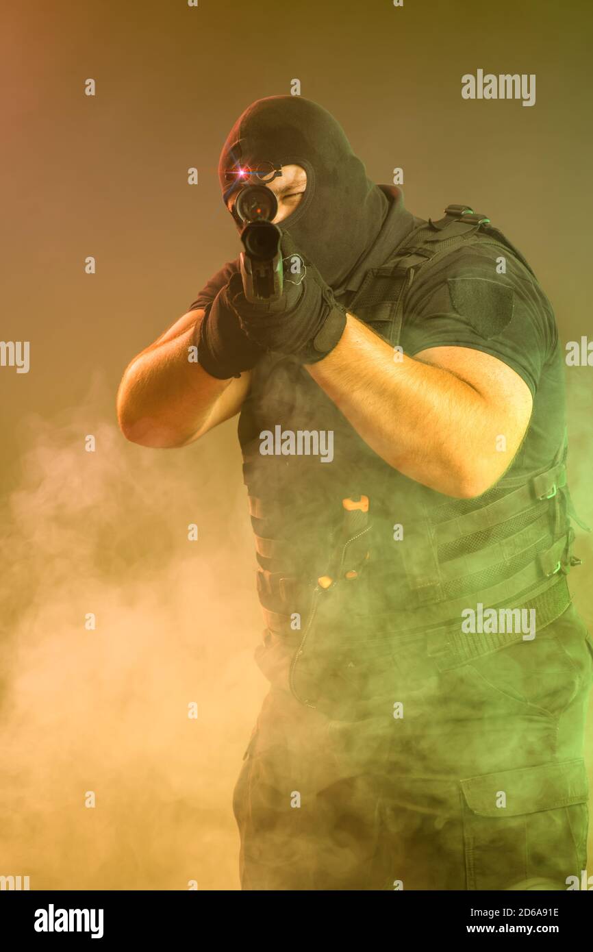 Soldier comes out of the smoke on the battlefield. The concept of ...