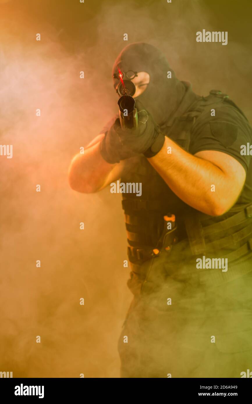 Soldier comes out of the smoke on the battlefield. The concept of ...