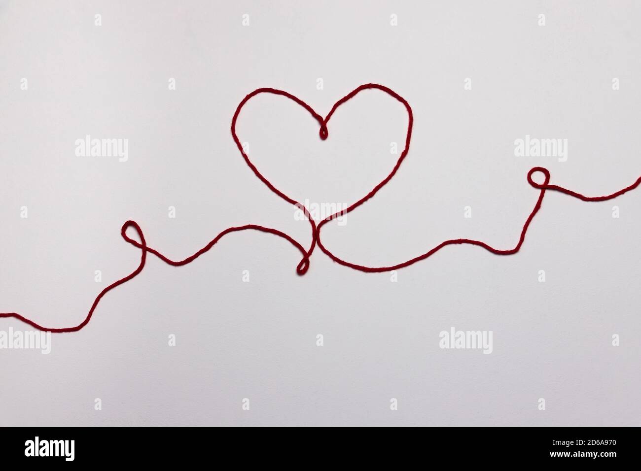 Heart shape made with red thread. Valentine's day, love message on ...