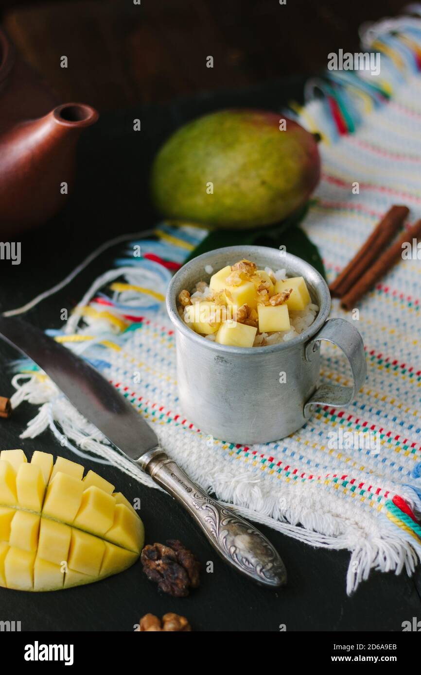 Sticky rice with mango fruit and nuts Stock Photo - Alamy