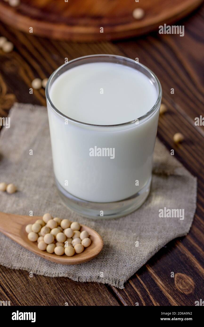 Soy milk with soy beans around it Stock Photo - Alamy