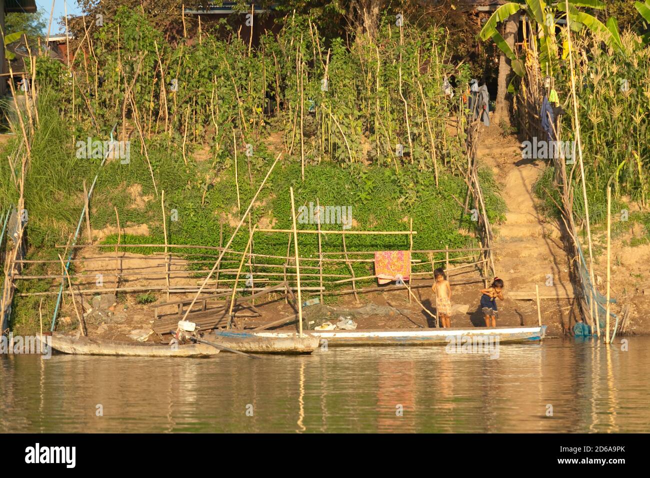 Mekong River Laos from the water showing riverbank activity and boats ...