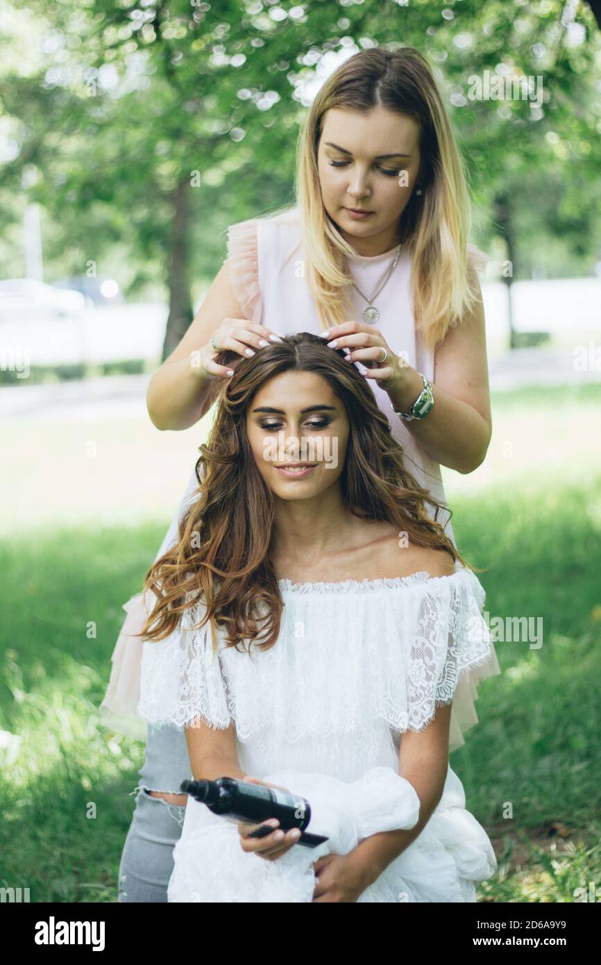 Hairdressing, Master create beautiful hairstyle for young woman Stock ...