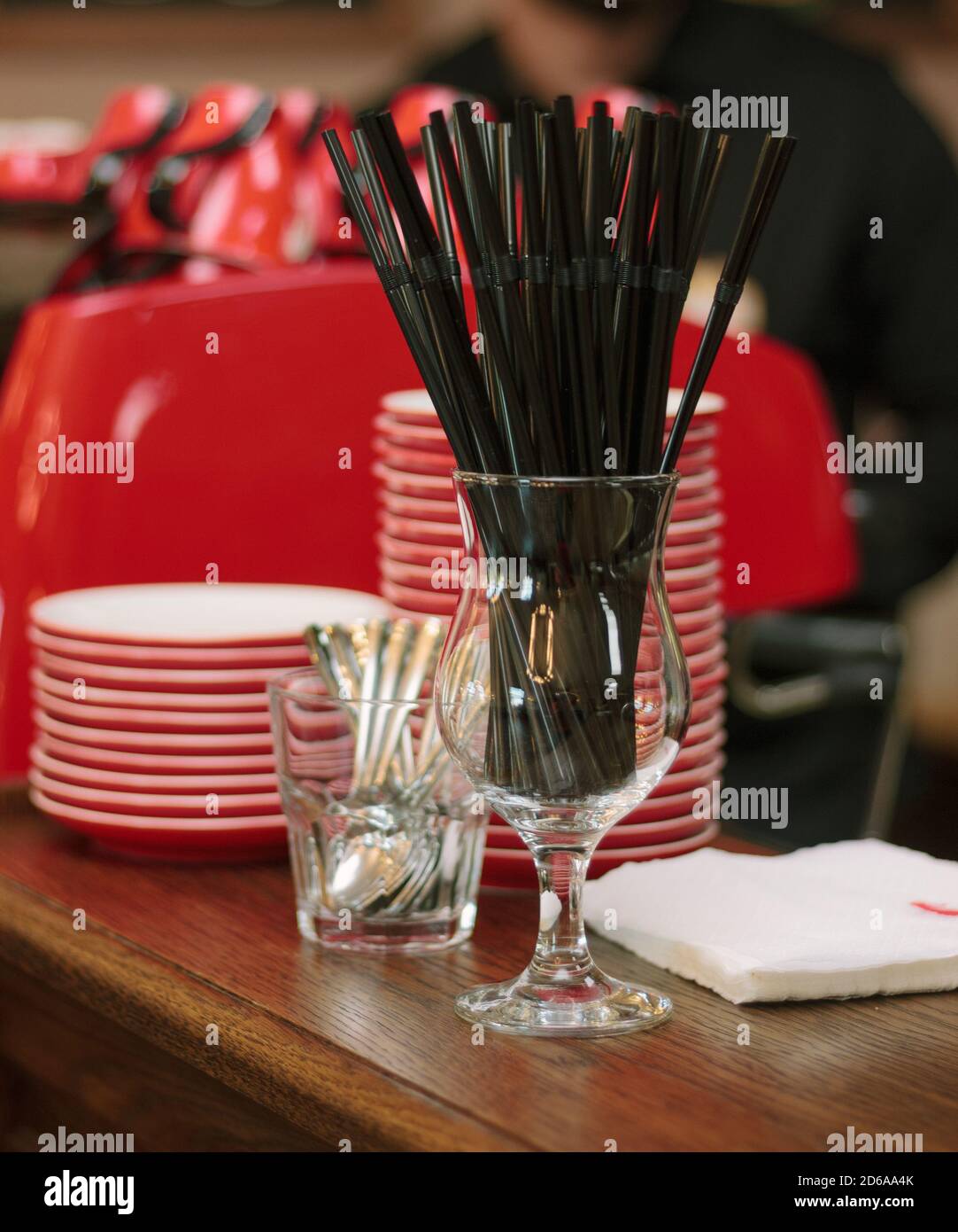 Black cocktail tubes in a transparent glass on bar Stock Photo - Alamy
