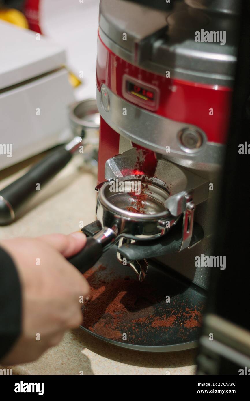 Coffee grinder grounding coffee beans to powder Stock Photo - Alamy