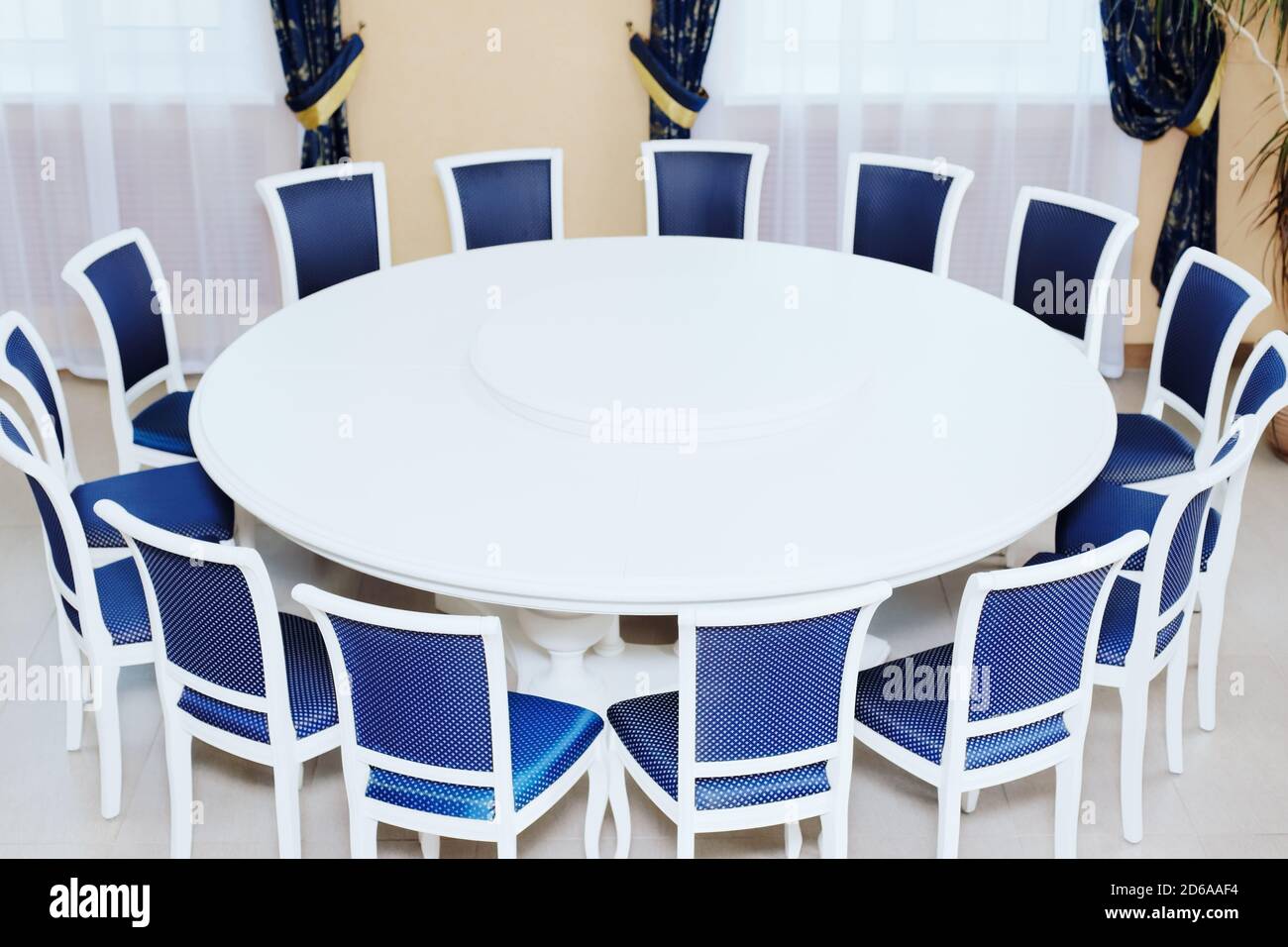 Empty white round conference table and chairs. Diplomatic background ...