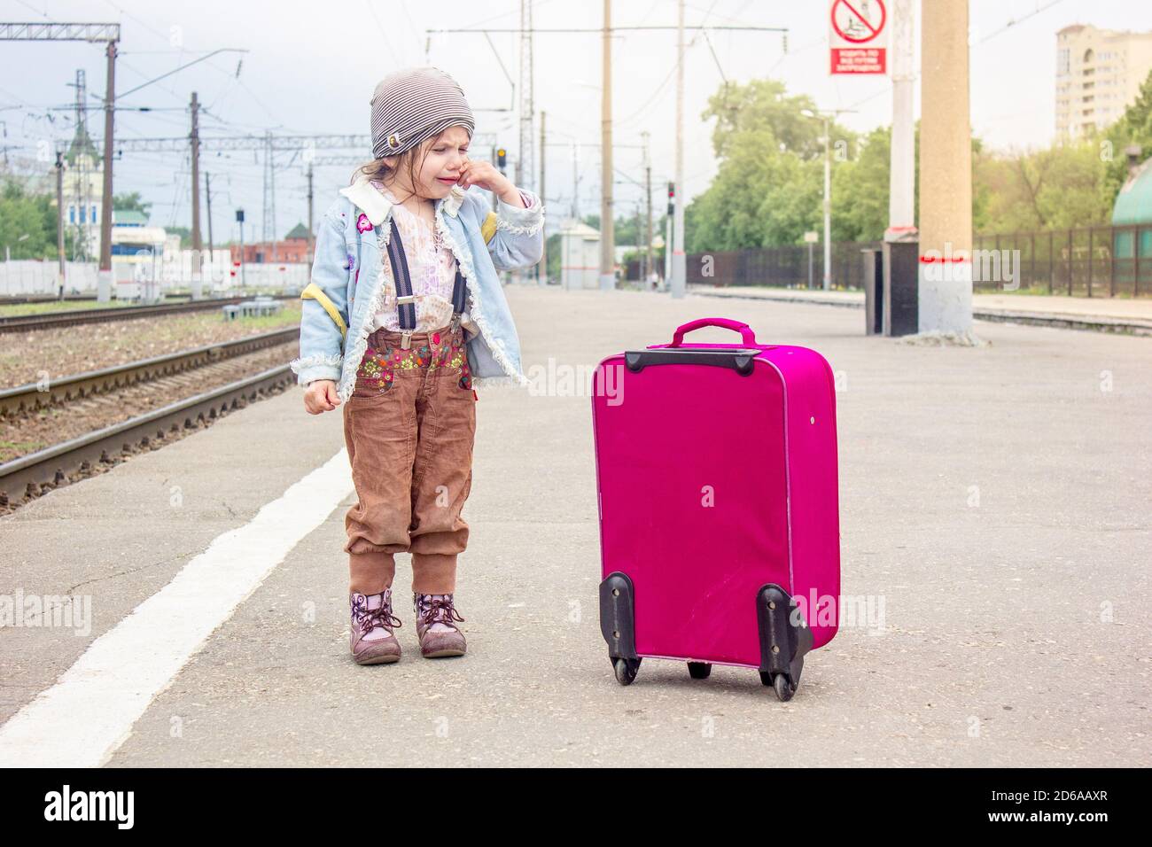 Little girl crying on the railway station, she dont want to leave Stock ...