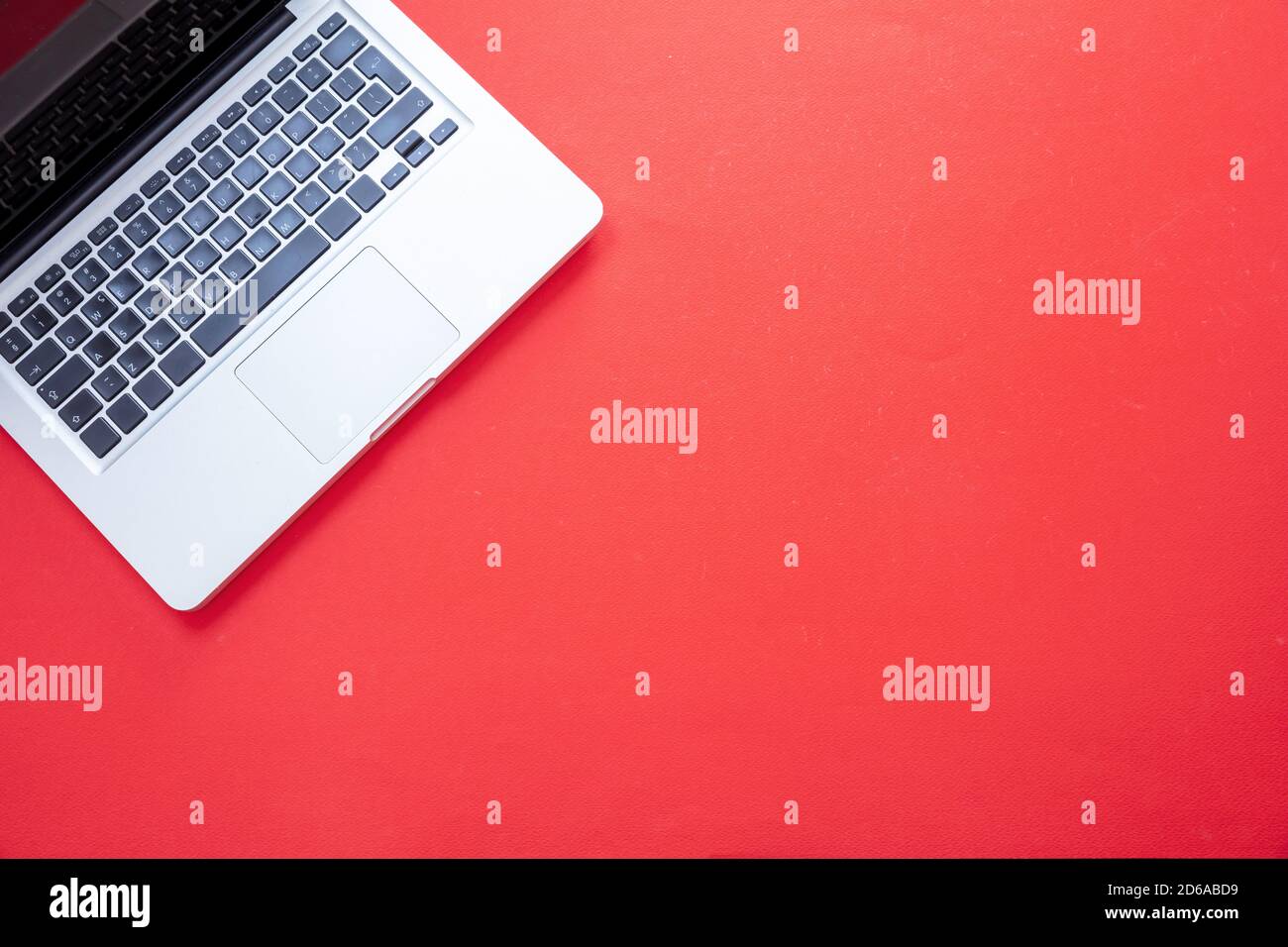 Laptop computer on bright red color background. Open laptop metal ...