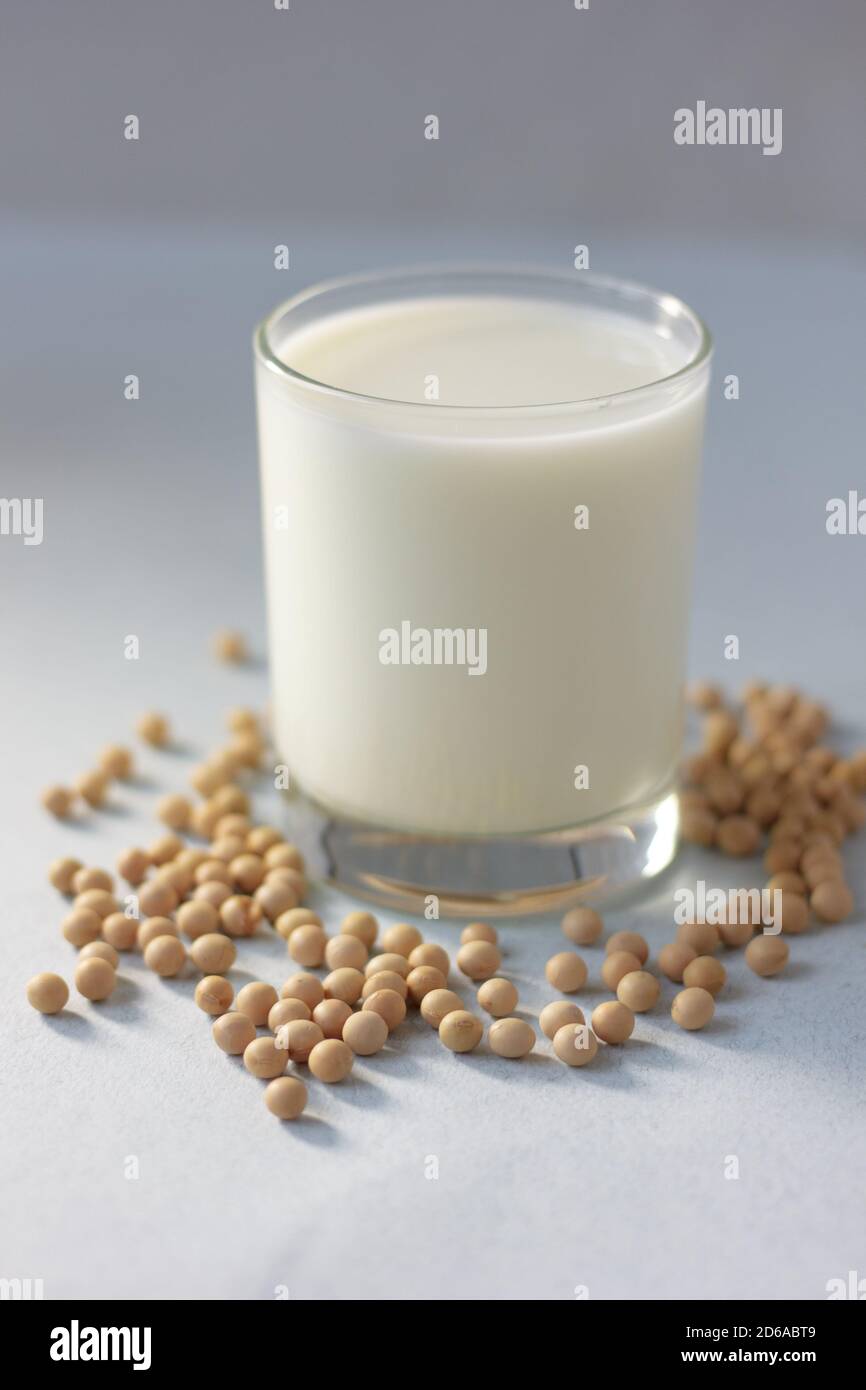 Soybean milk with soy beans around it Stock Photo - Alamy