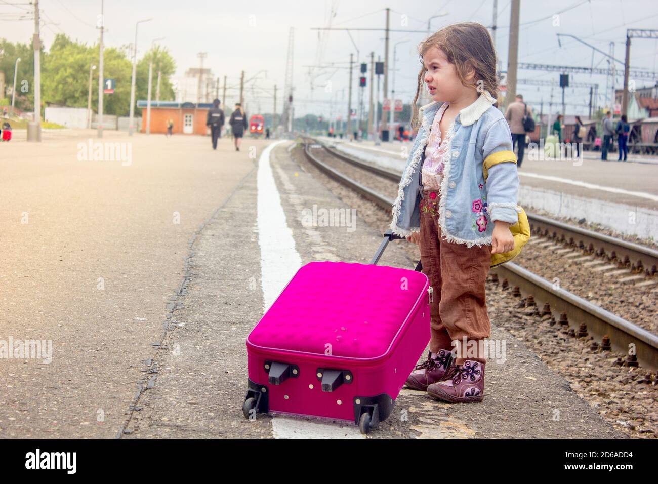 Little girl crying on the railway station, she dont want to leave Stock ...