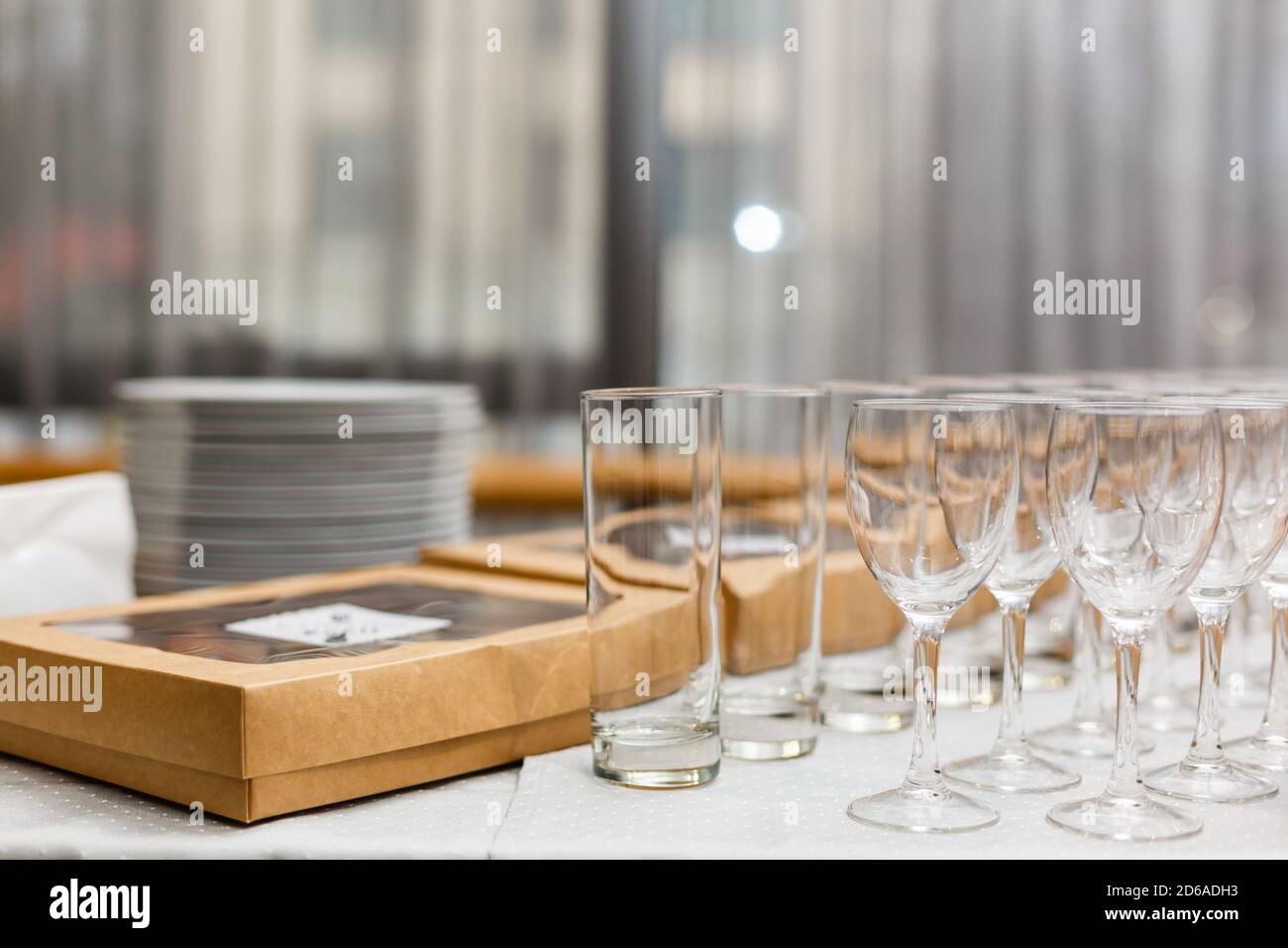 Set of empty wine glasses in a row, white background. Party in a ...