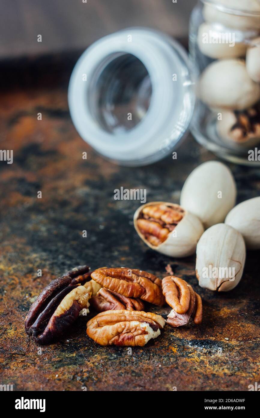 Pecan nuts inside glass jar on rustic surface Stock Photo - Alamy