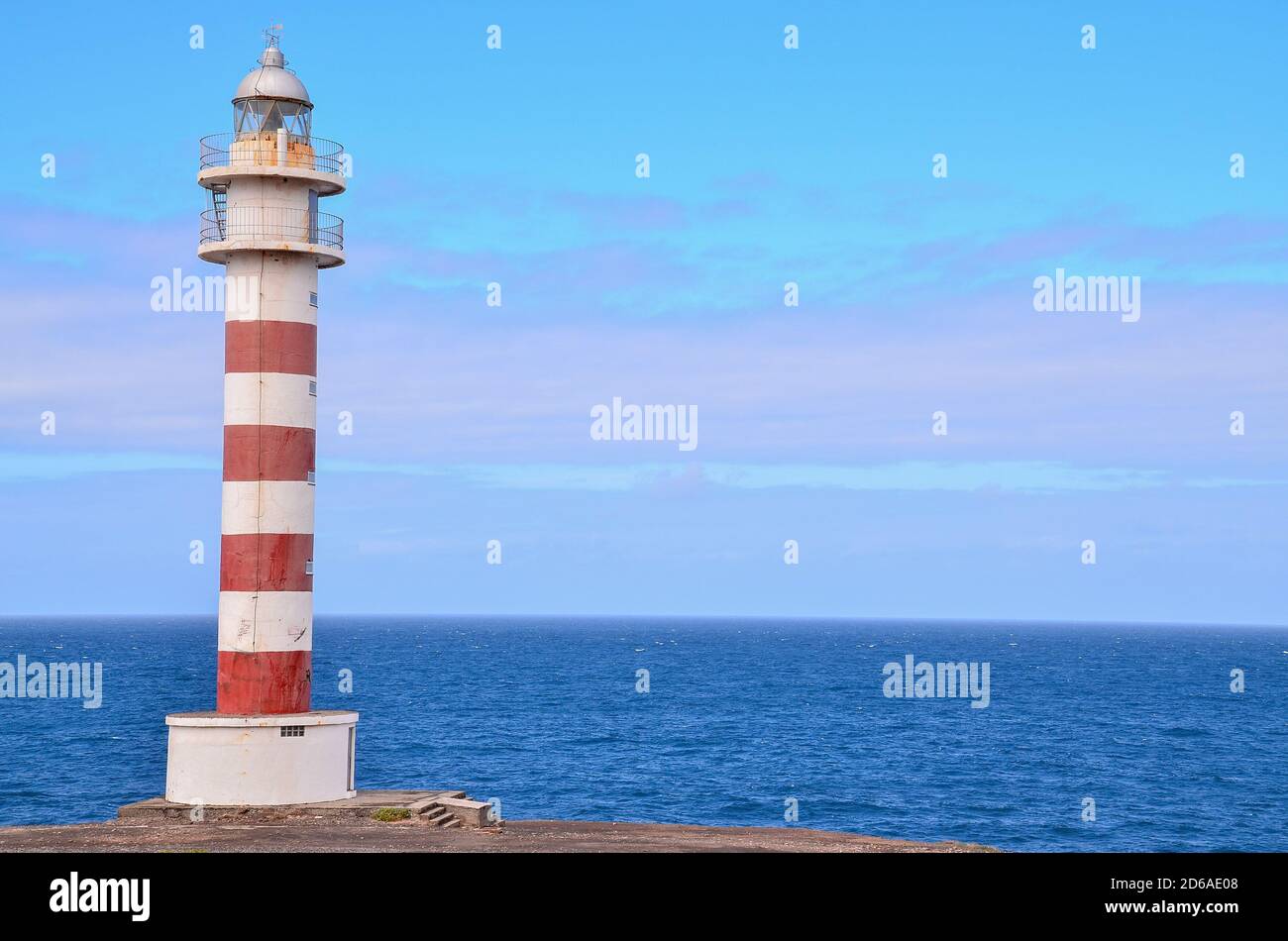 High Lighthouse near the Coast Stock Photo - Alamy