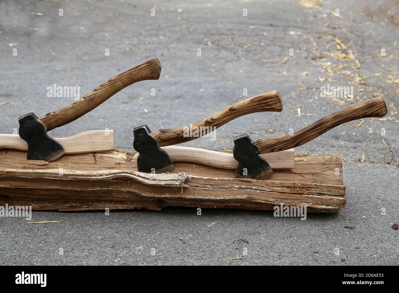 Closeup shot of three axes stick out in a tree trunk Stock Photo - Alamy