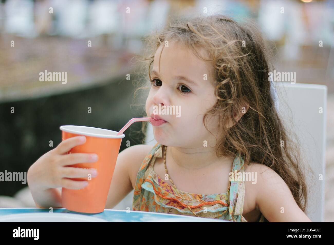 Little kid drinks cola at the cafe or restaurant Stock Photo - Alamy