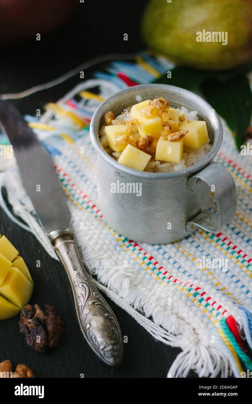 Sticky rice with mango fruit and nuts Stock Photo - Alamy
