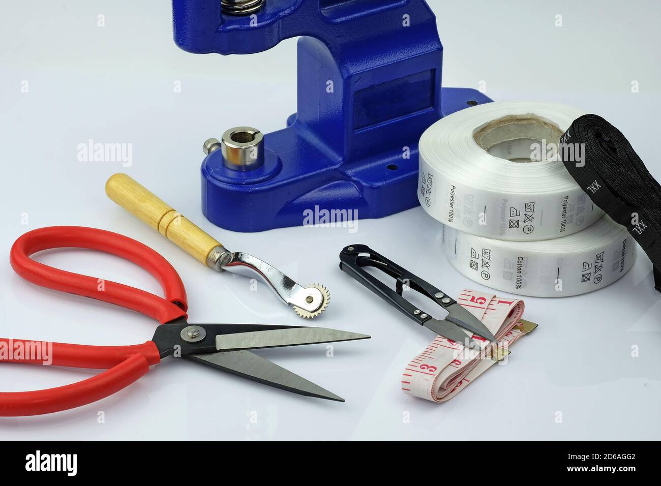 Press, scissors, thread cutter, size box on a white background. A set ...