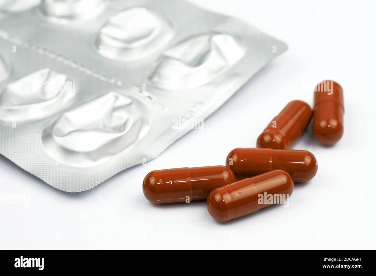 Brown capsules and blister on a white background. Liver protection ...