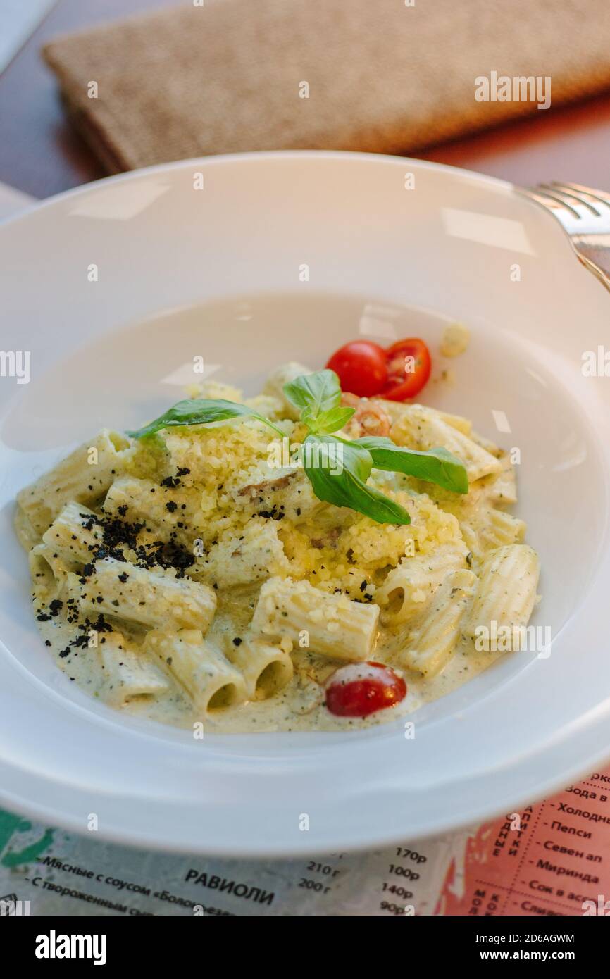 Italian food - rigatoni pasta with basil and black truffle Stock Photo ...