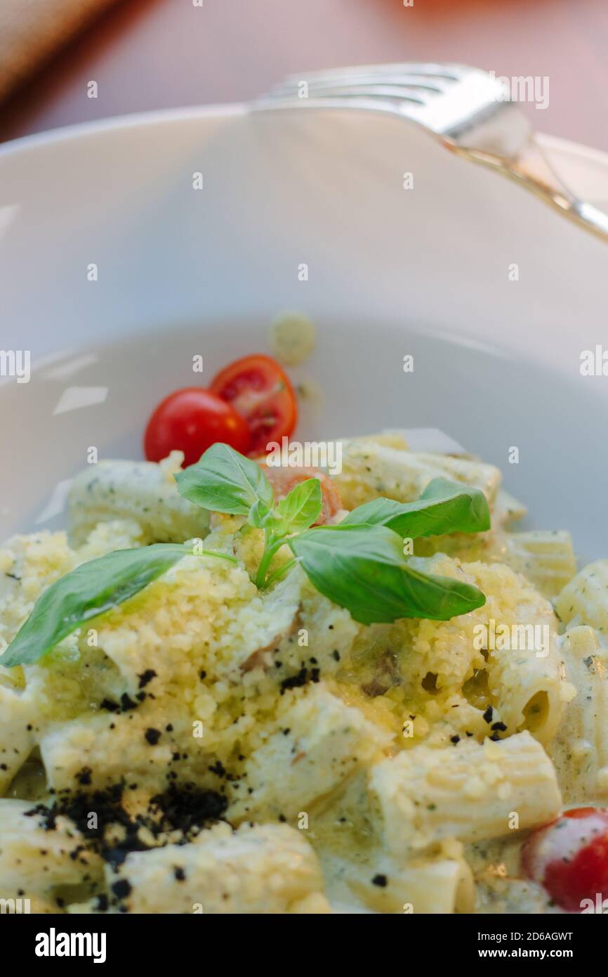 Italian food - rigatoni pasta with basil and black truffle Stock Photo ...