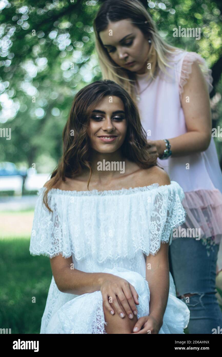 Hairdressing, Master create beautiful hairstyle for young woman Stock ...