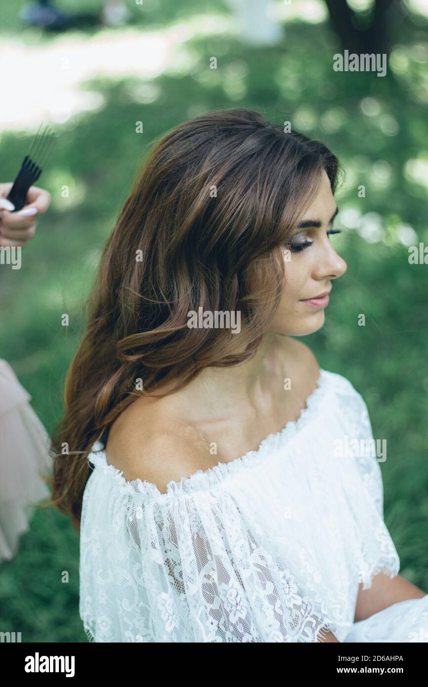 Hairdressing, Master create beautiful hairstyle for young woman Stock ...