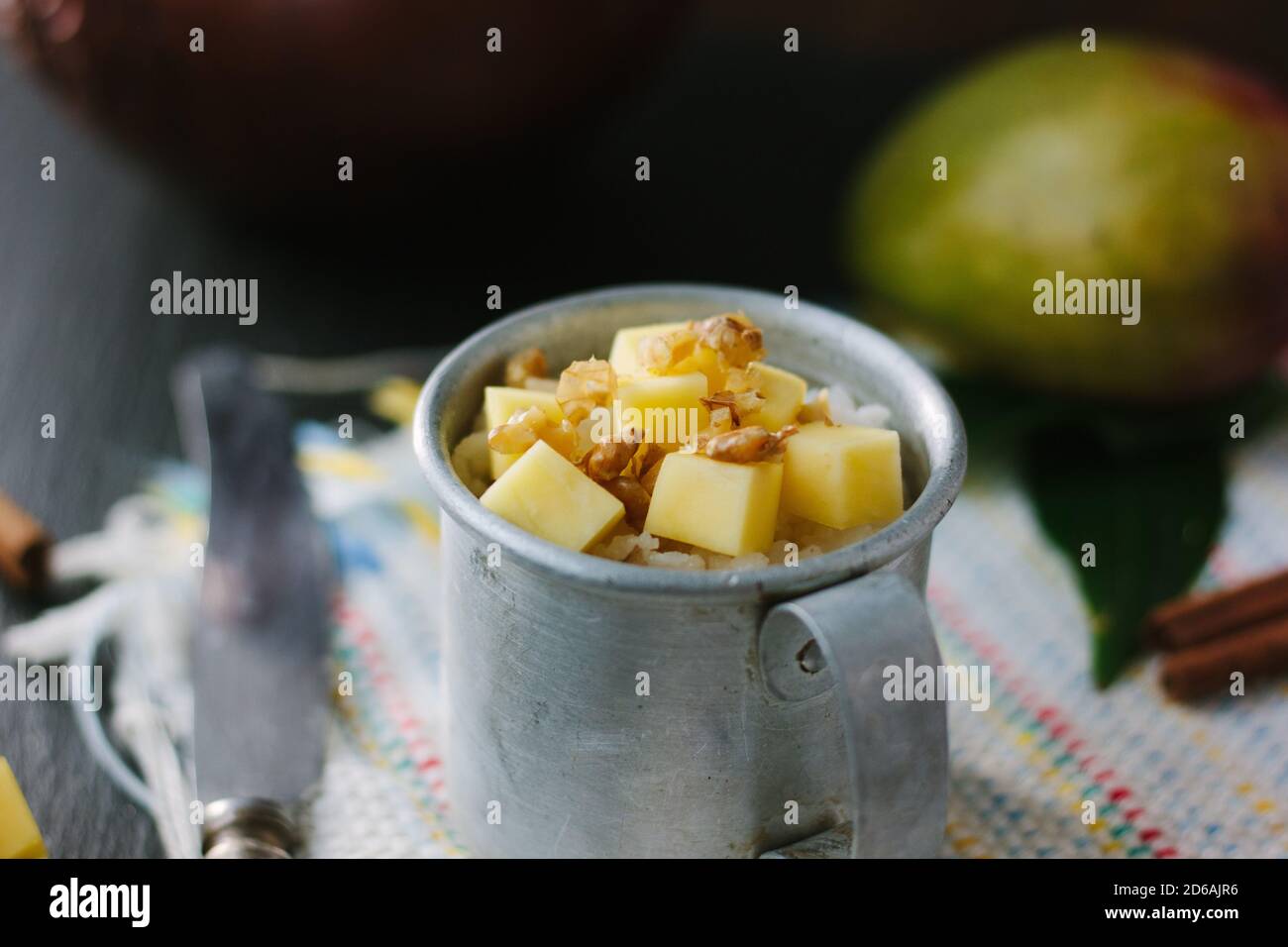 Sticky rice with mango fruit and nuts Stock Photo - Alamy