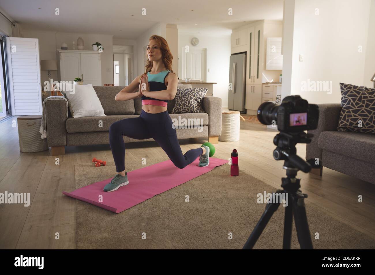 Woman performing exercise home recording hi-res stock photography and ...