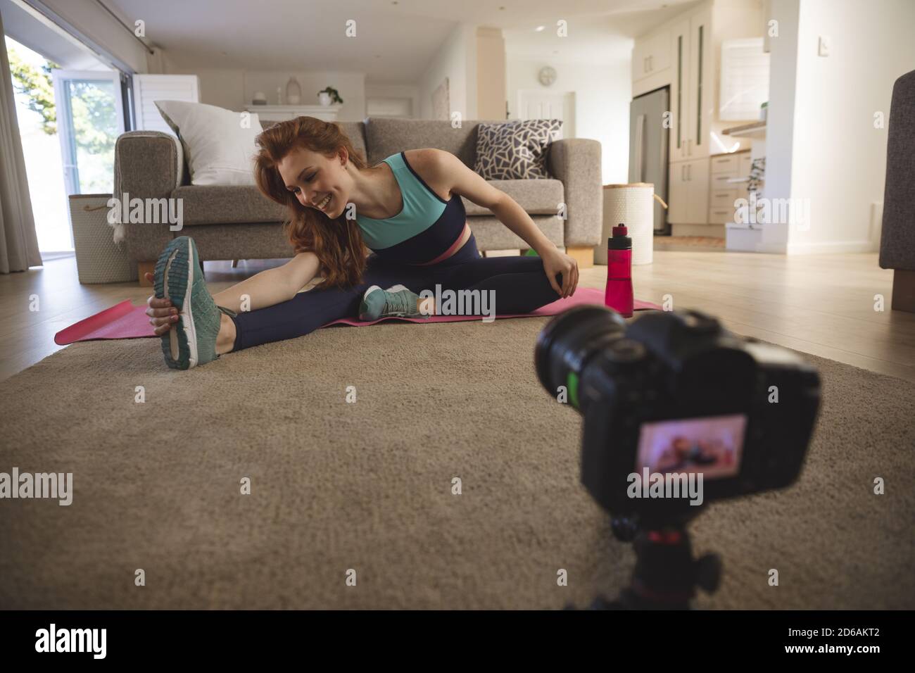Woman performing exercise home recording hi-res stock photography and ...
