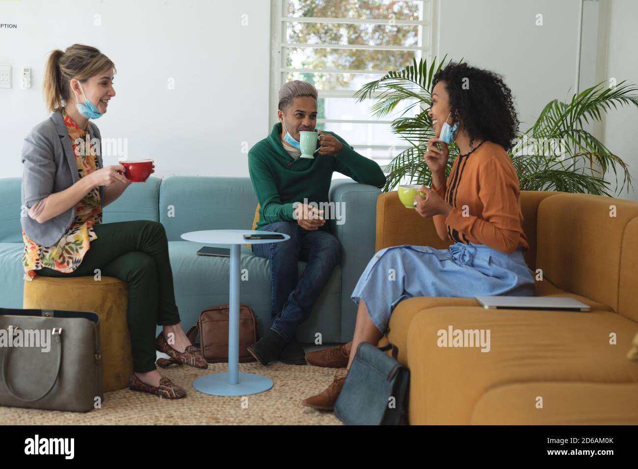 Office colleagues drinking coffee together at office Stock Photo - Alamy