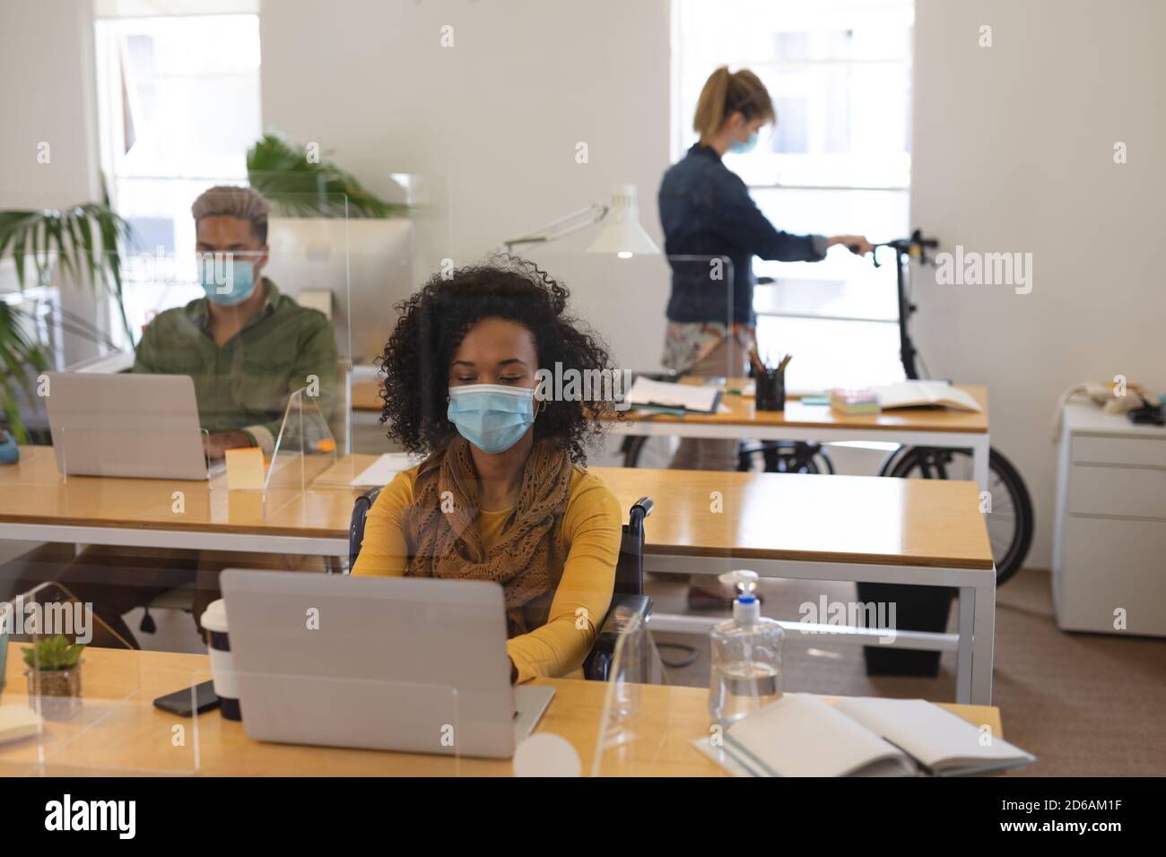 Office colleagues wearing face masks working in office Stock Photo - Alamy