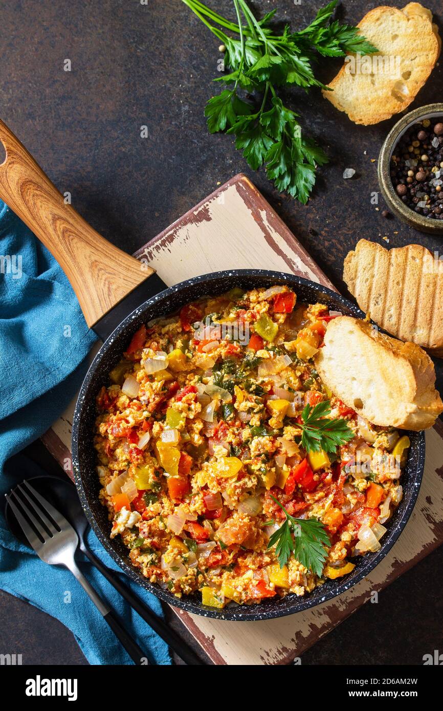 Turkish cuisine. Menemen Scrambled eggs in a cast iron frying pan on a ...