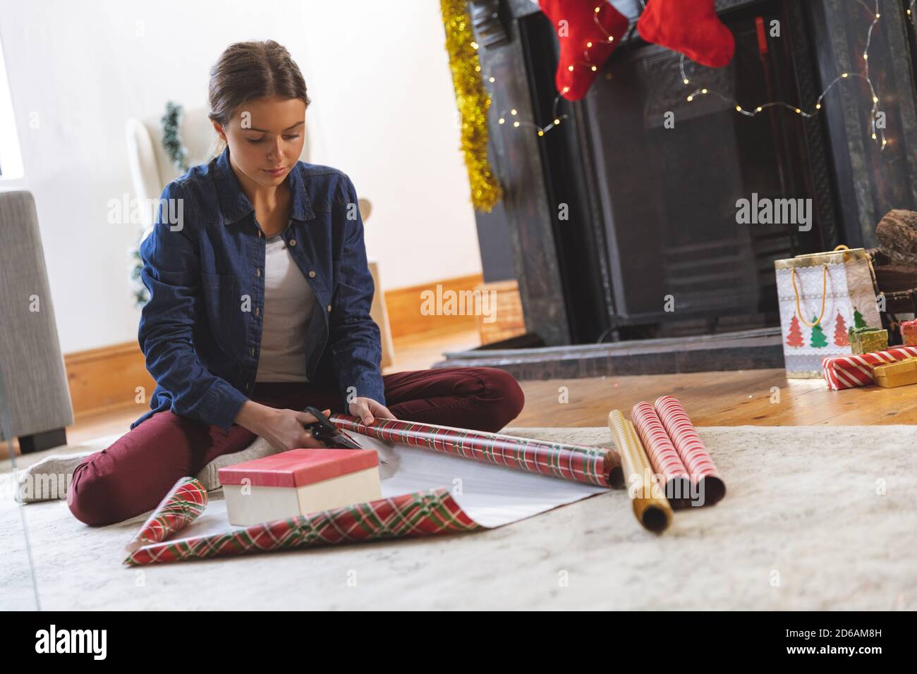 Woman wrapping Christmas presents at home Stock Photo - Alamy