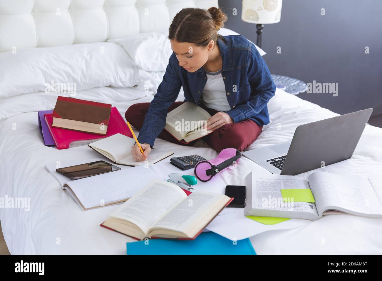 Woman sitting on bed taking hi-res stock photography and images - Alamy
