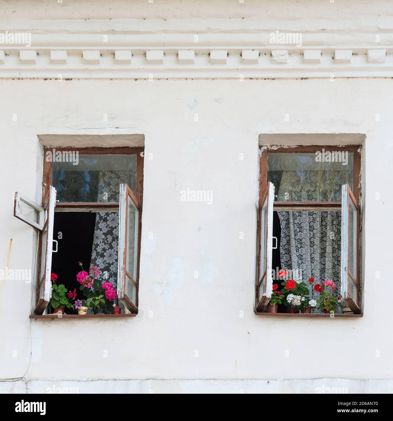 Old rustic house with windows and blooming flowers Stock Photo - Alamy