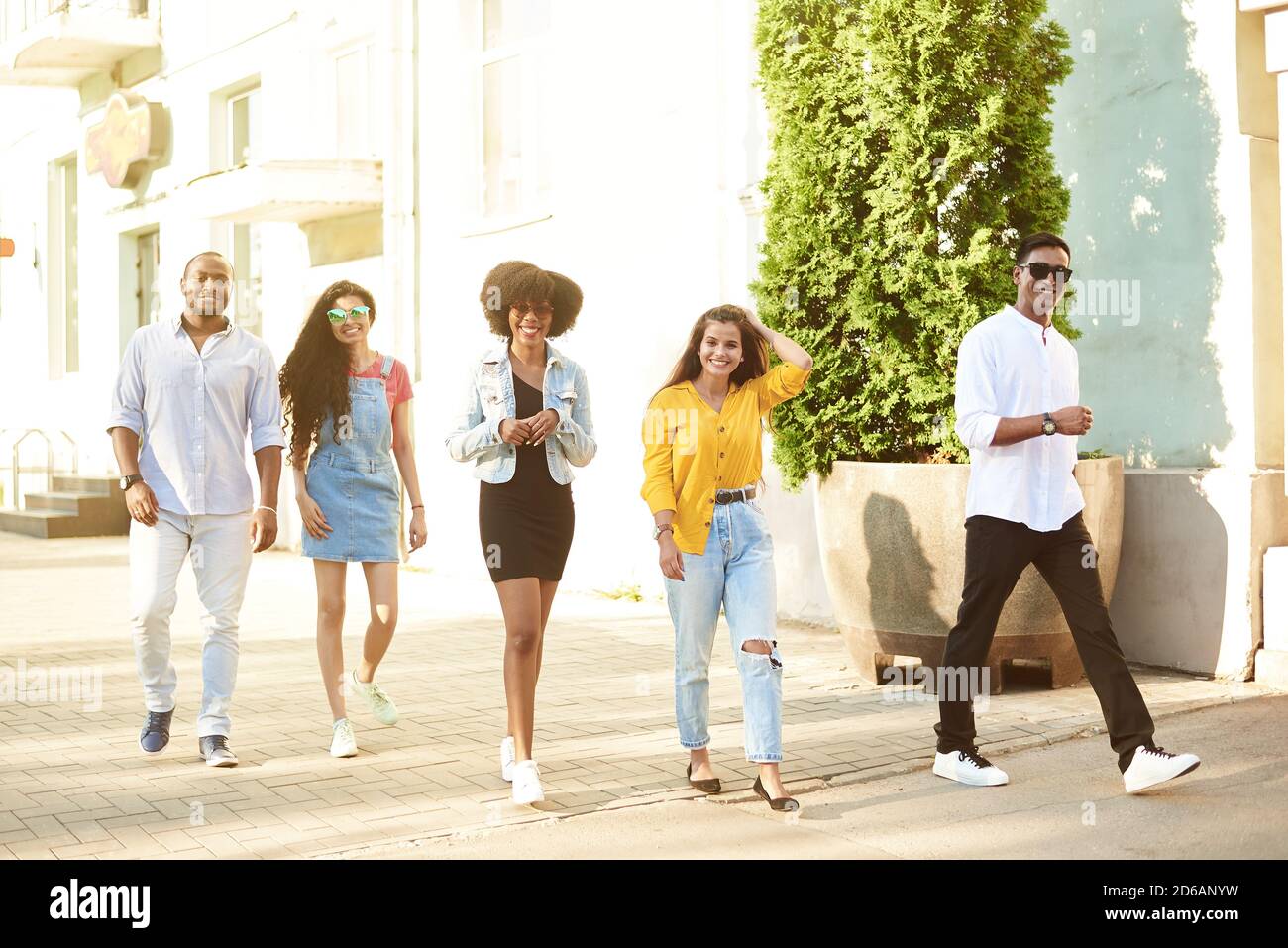 College students walking together outdoors. Young beautiful people of ...