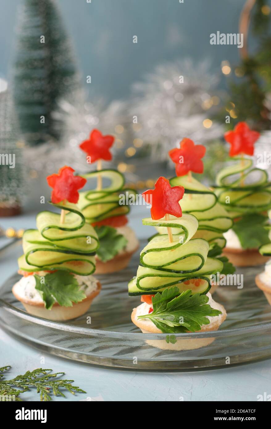 Festive canapes in the shape of Christmas trees made of cucumbers and ...