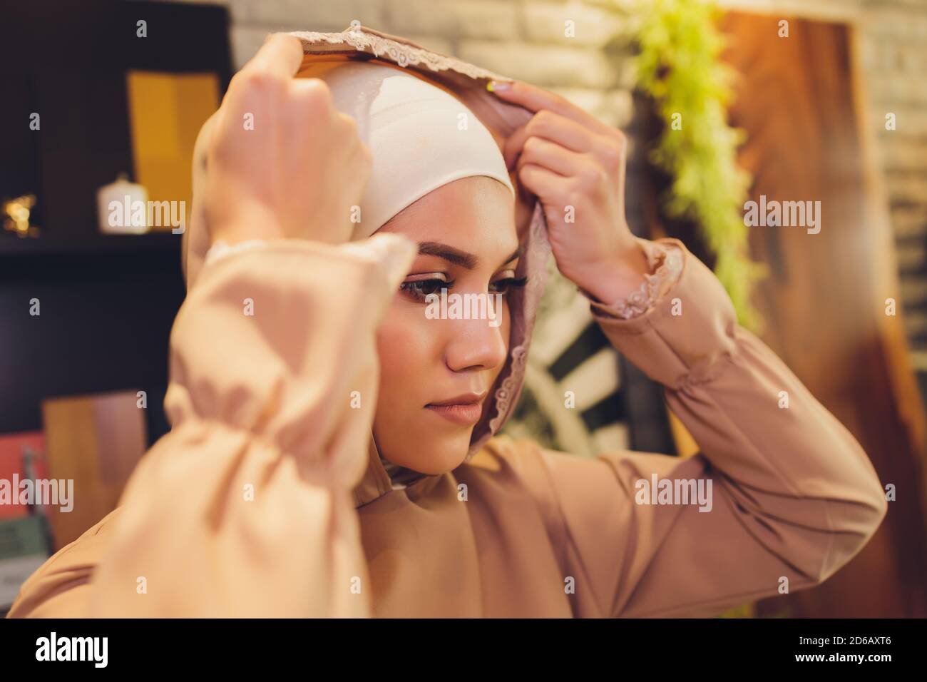Portrait of positive pretty young Arabian woman in pink headscarf ...