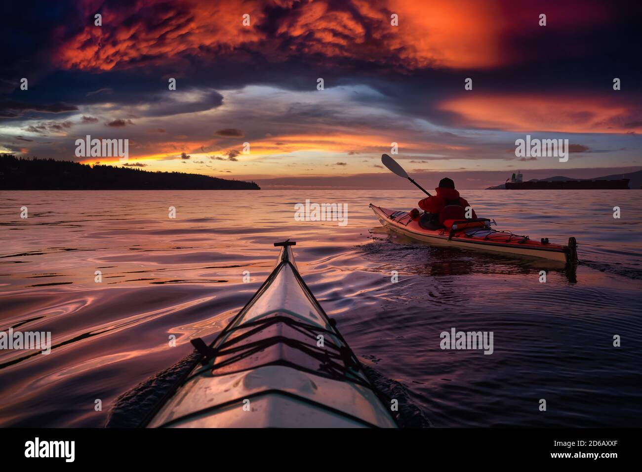 Adventure Man on a Sea Kayak at Sunset Stock Photo - Alamy