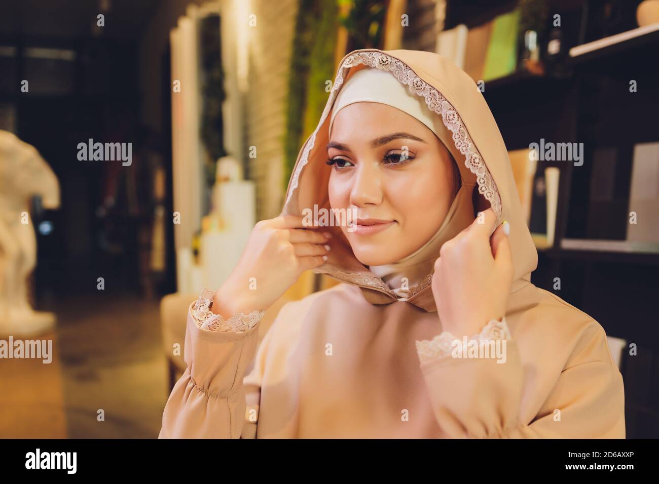 Portrait of positive pretty young Arabian woman in pink headscarf ...