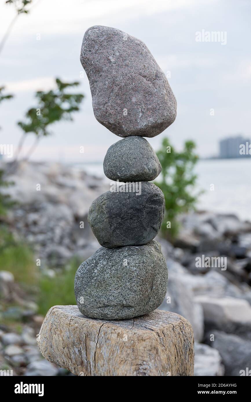 Four rocks balance and stack on top of the others Stock Photo - Alamy