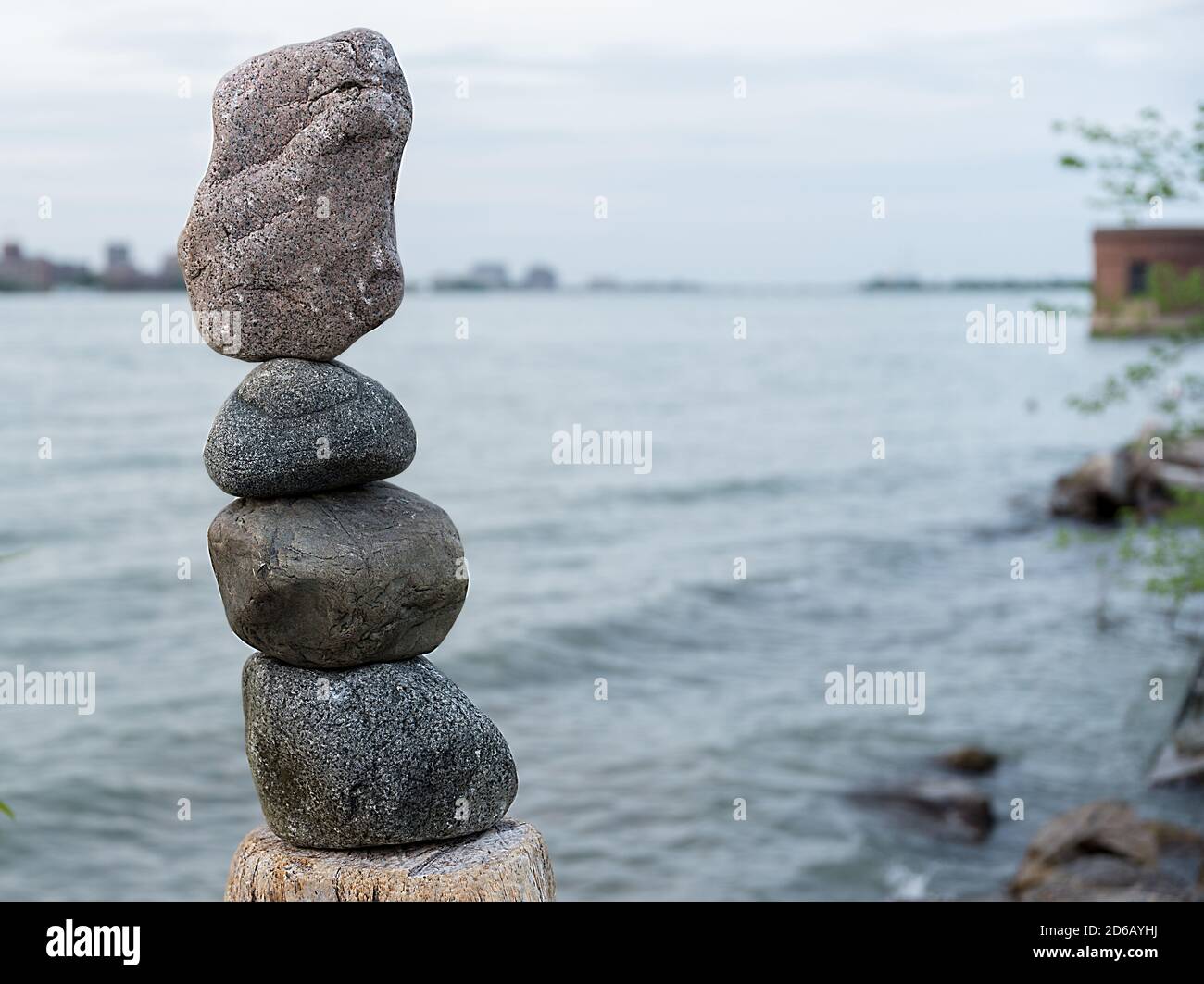Four rocks balance and stack on top of the others Stock Photo - Alamy