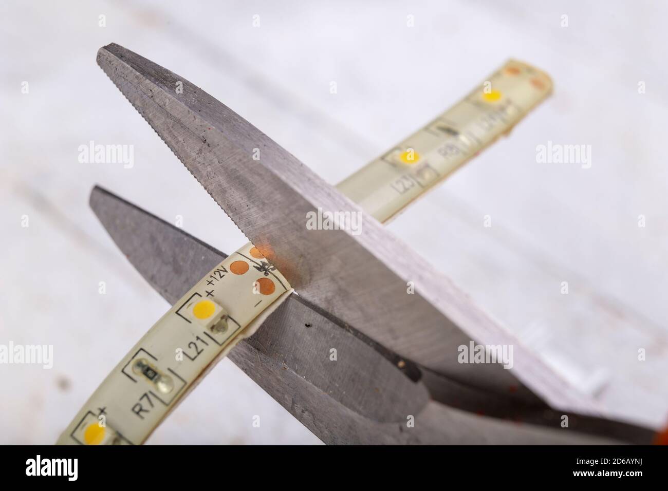 Cutting the led strip with metal scissors. Electric accessories for ...